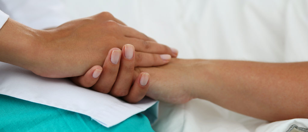 Doctor holding patient's hand - American Osteopathic Board of ...
